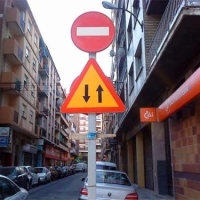 When on a road where two traffic signs apparently contradict each other ...